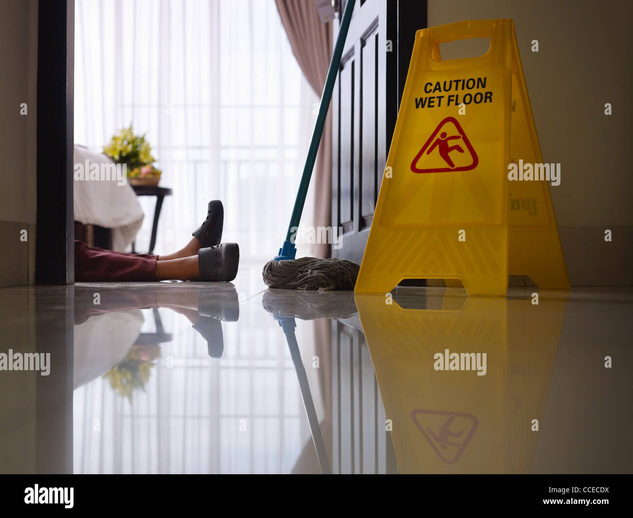 housemaid had accident at work while cleaning floor in hotel room. Side ...
