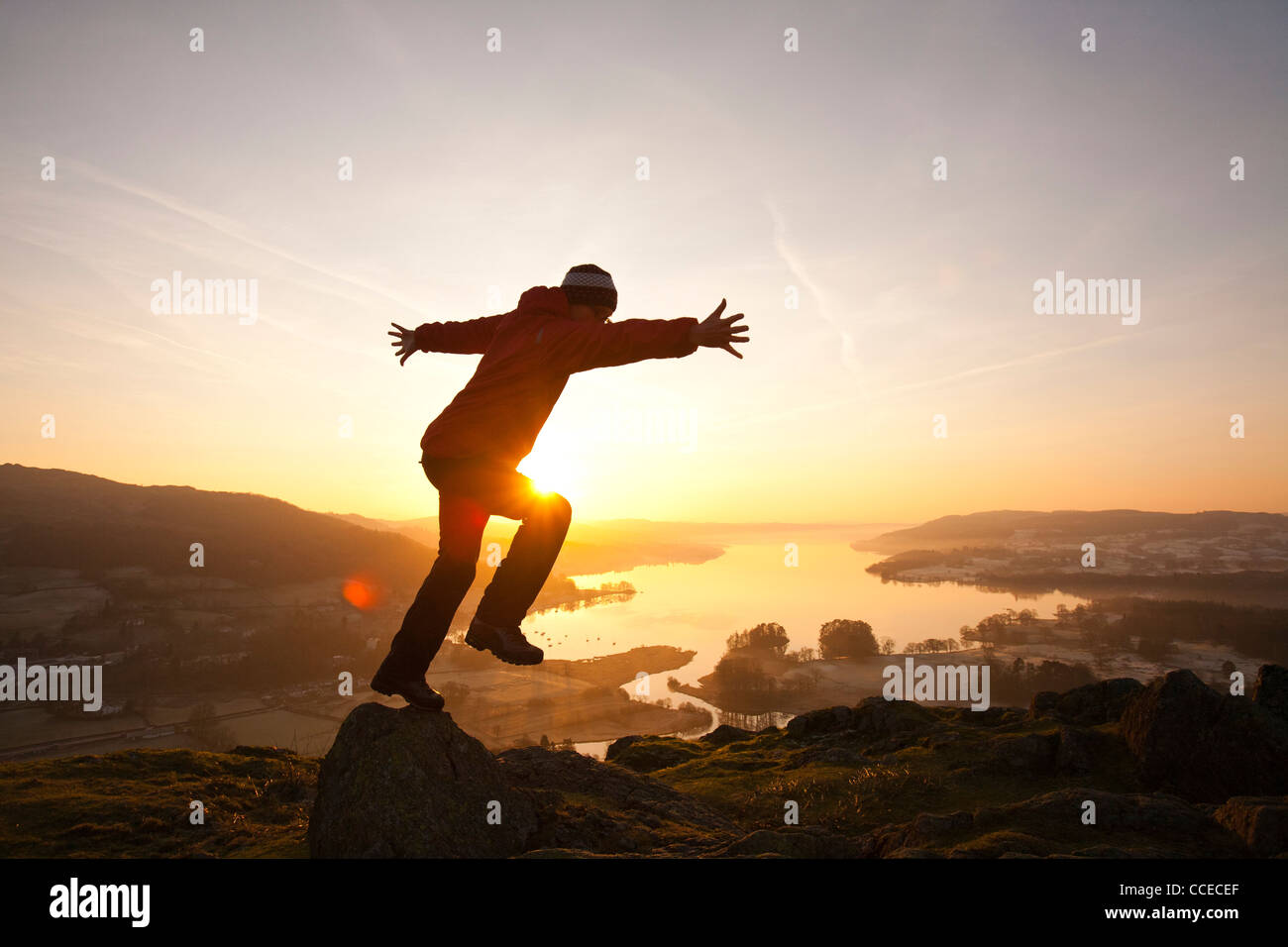 A man jumping for joy at sunrise over Lake Windermere from Todd Crag ... A man jumping for joy at sunrise over Lake Windermere from Todd Crag ...