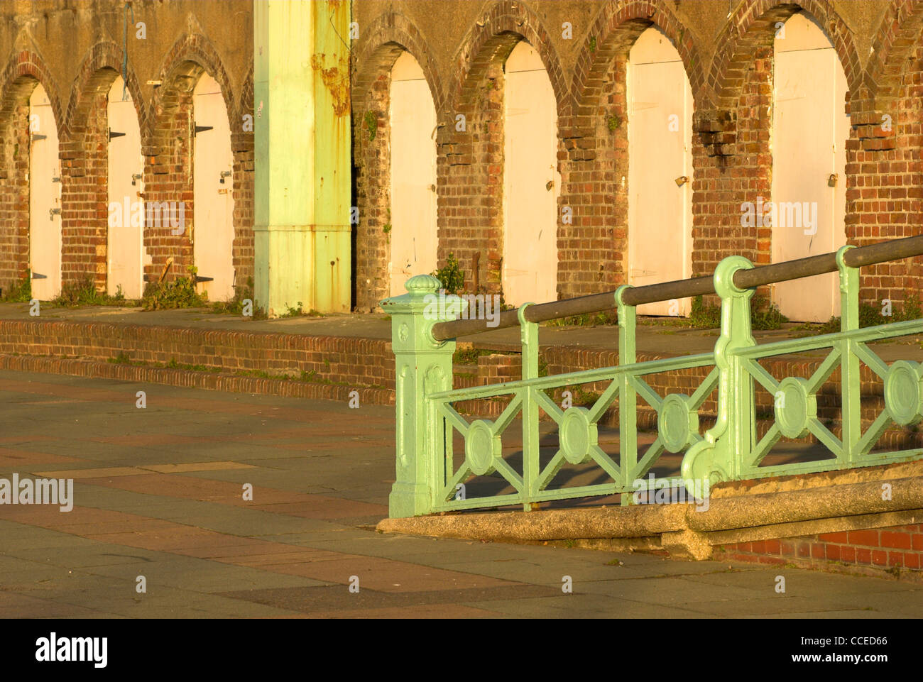 Arches and familiar green railings on Brighton seafront, East Sussex ...