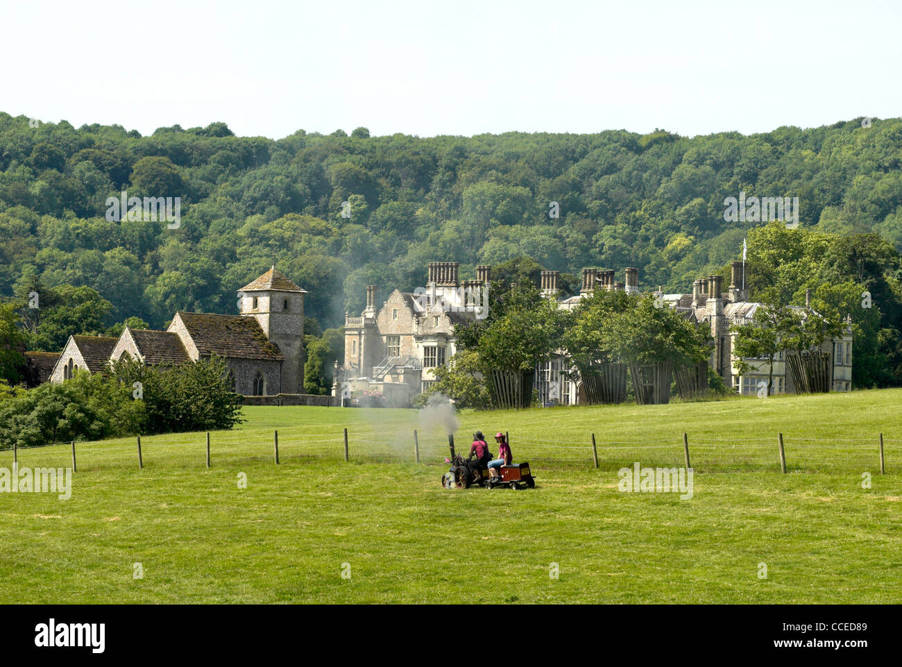 A couple on a miniature steam engine with Wiston House and the South ...