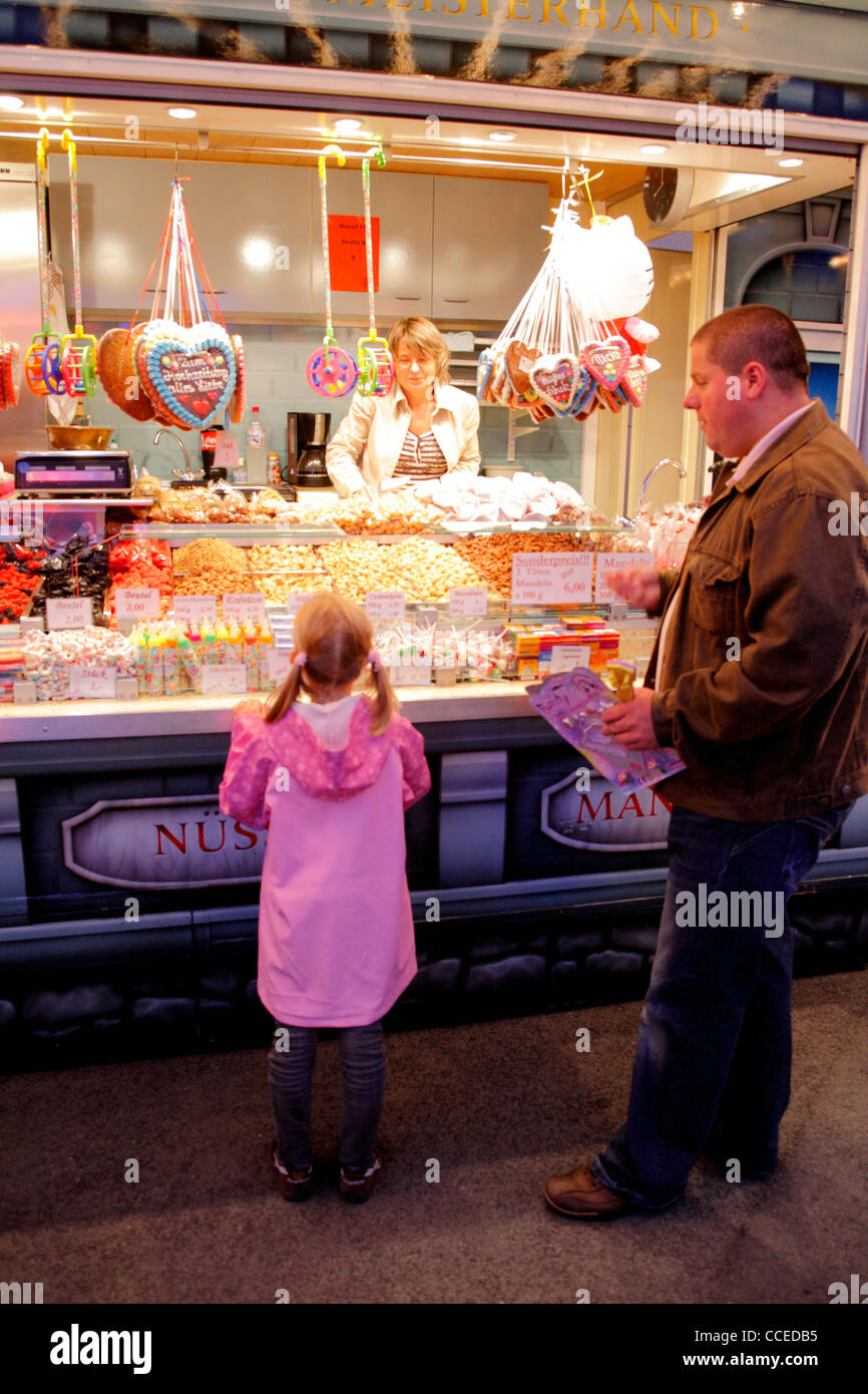 father and daughter infront of german mobile sales booth at fair buying ...