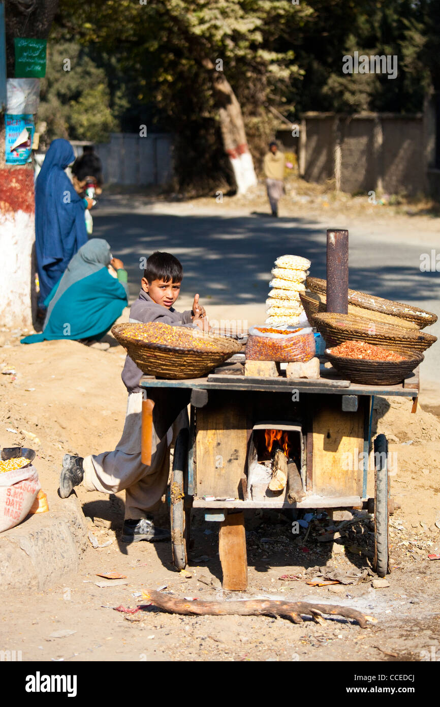Young boy selling roasted corn in Punjab Province, Pakistan Stock Photo ...