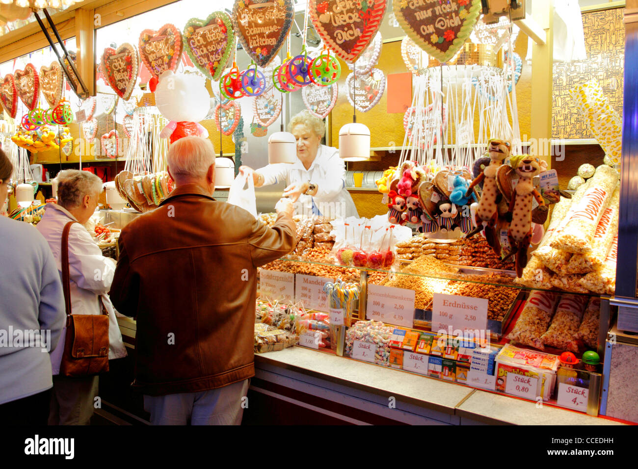 female seller with customers at german mobile sales booth at fair ...