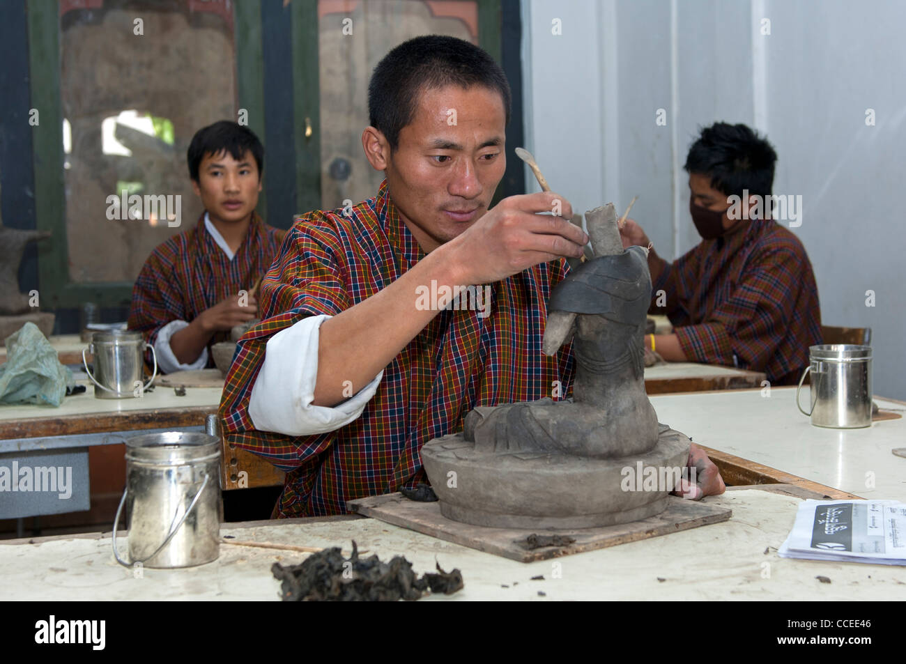 Sculpture artist in national dress at the National Institute for ...