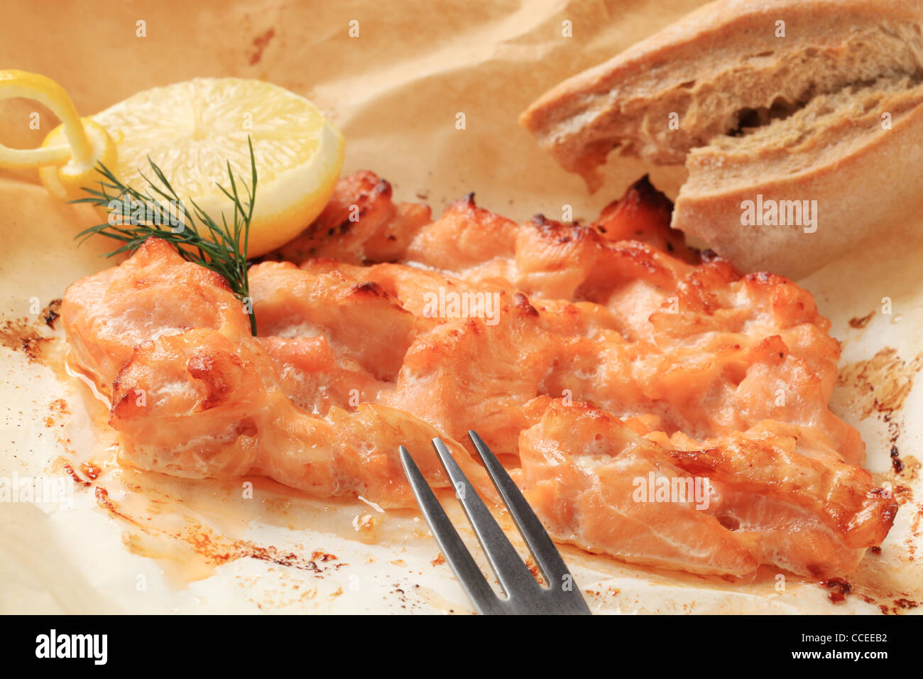Chopped salmon with lemon and bread roll Stock Photo - Alamy