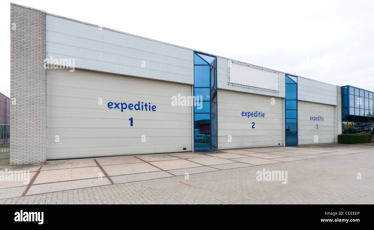 three loading docks at a small warehouse Stock Photo - Alamy