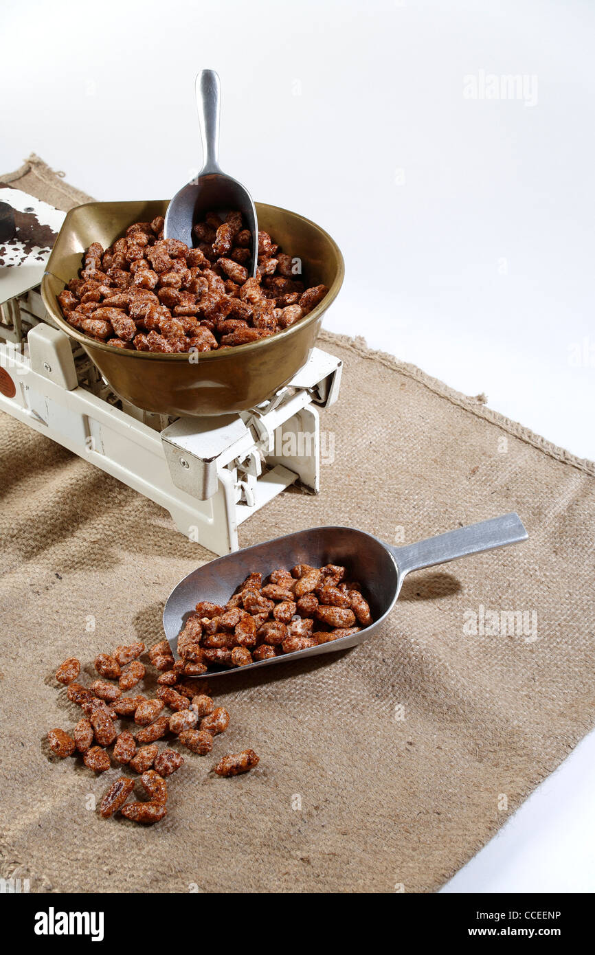 still life old scale with roasted cinnamon almonds and two scoops ...