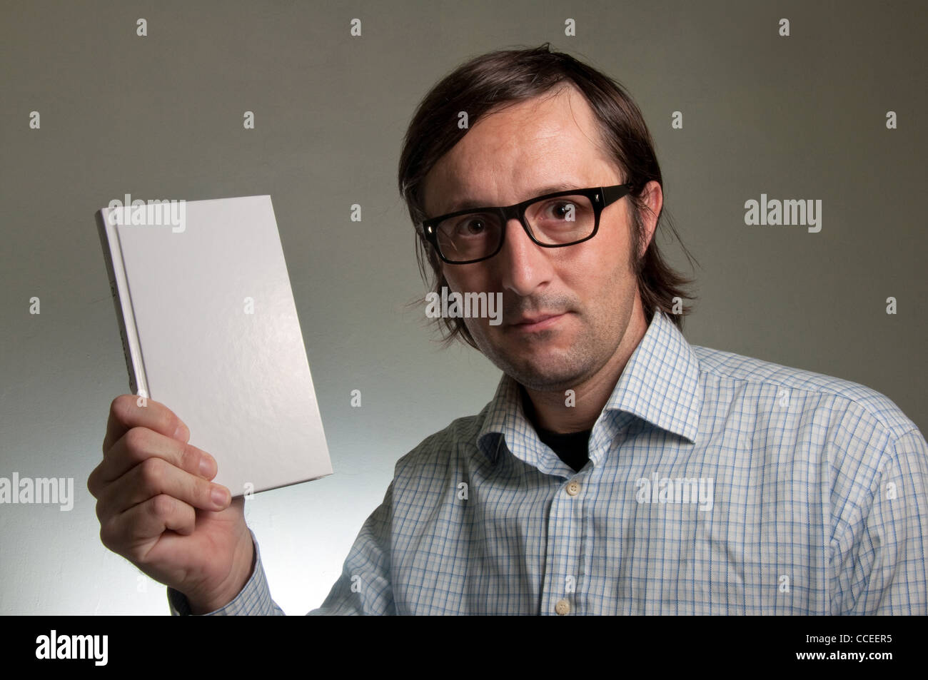 Nerd male holding a book with empty white covers, this image is a ...