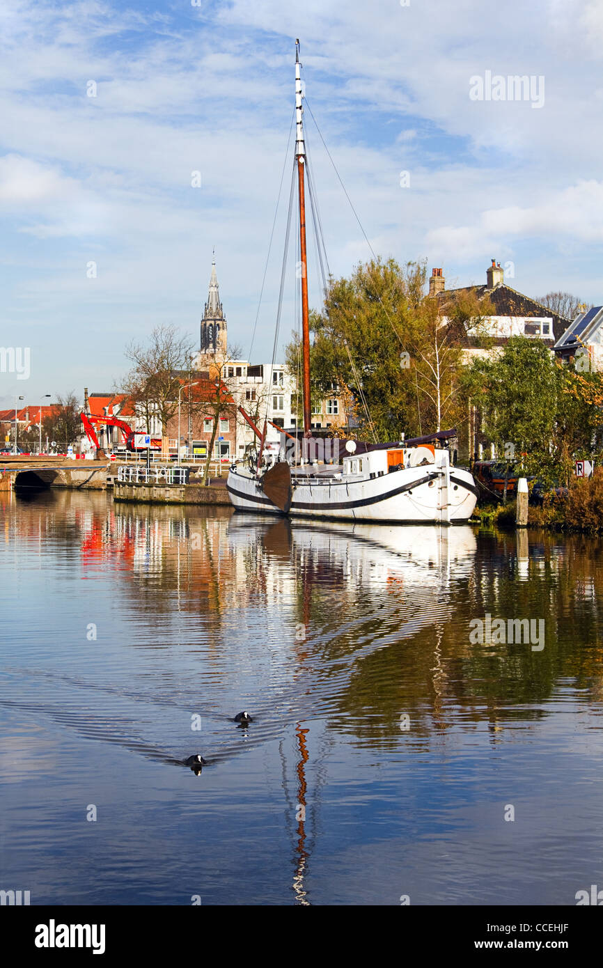 Canal with view to Delft, the Netherlands, with church tower, old ...