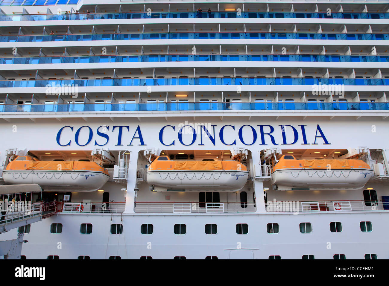 Enormous Costa Concordia cruise ship with lifeboats (side view) docked ...