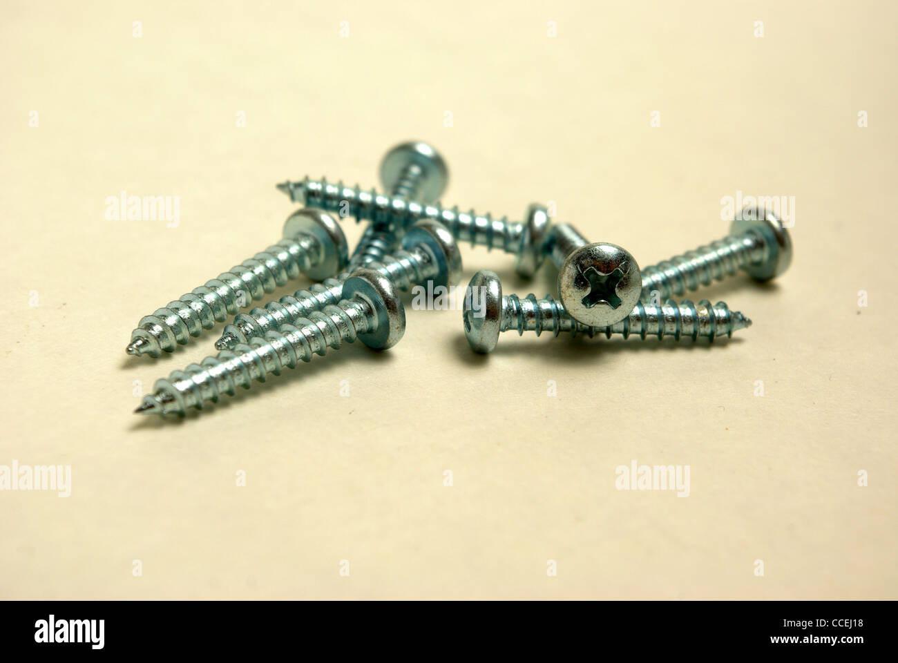 A pile of screws are on a plain white background Stock Photo - Alamy