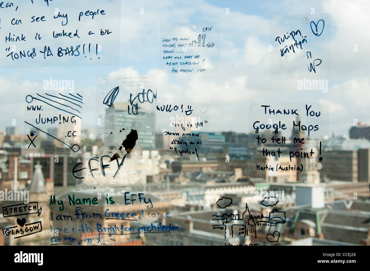 view of Glasgow through window with text messages on glass and bright ...