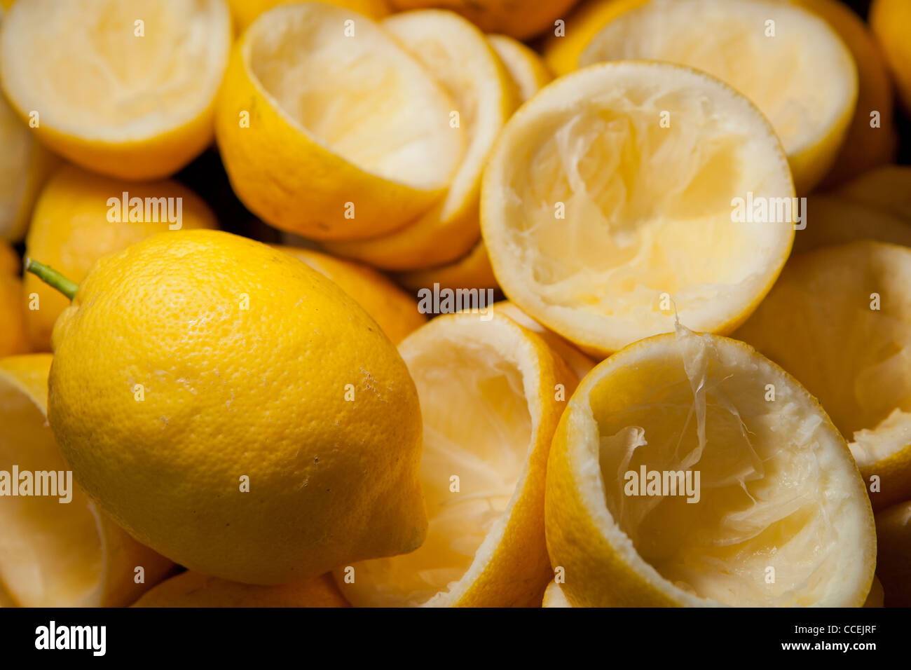 Lots of squeezed lemons with whole lemon after squeezing lemon's in a ...