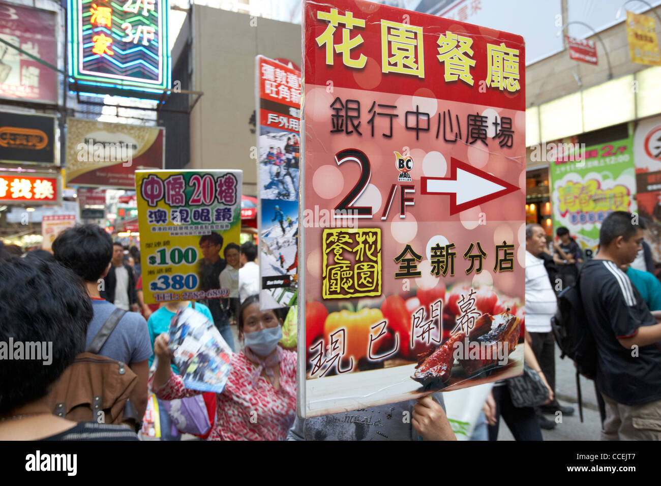 chinese women holding up shop and restaurant advertising boards in rush ...