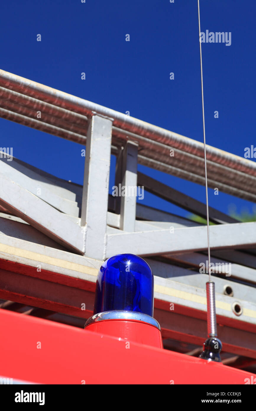 Ladder of a fire truck on the blue sky, emergency light on firetruck ...