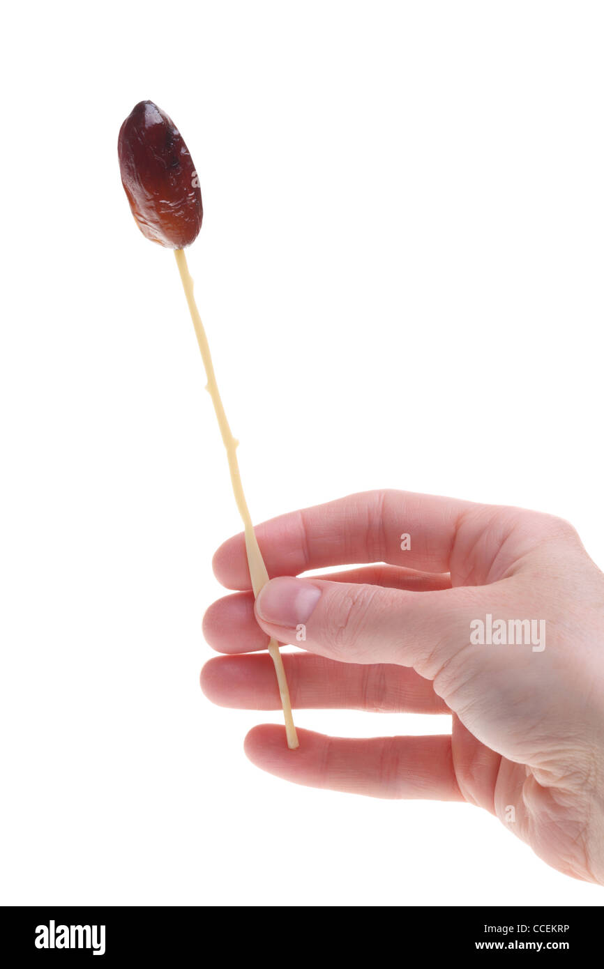 Dried date fruits in hand isolated on white background Stock Photo - Alamy