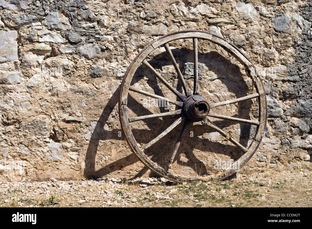wheel at a brickwall wagon stone wall Stock Photo - Alamy