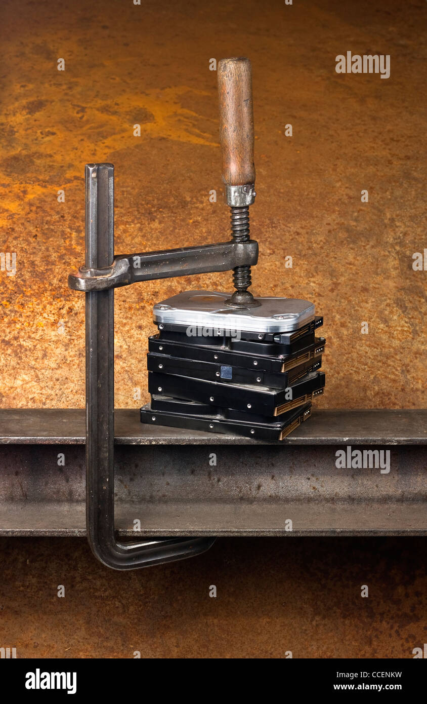 some hard disk drives compressed with a screw clampin rusty back Stock ...