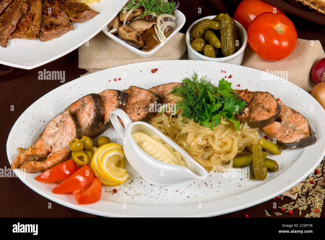 Many food dishes on the table. Fish dish close up Stock Photo - Alamy