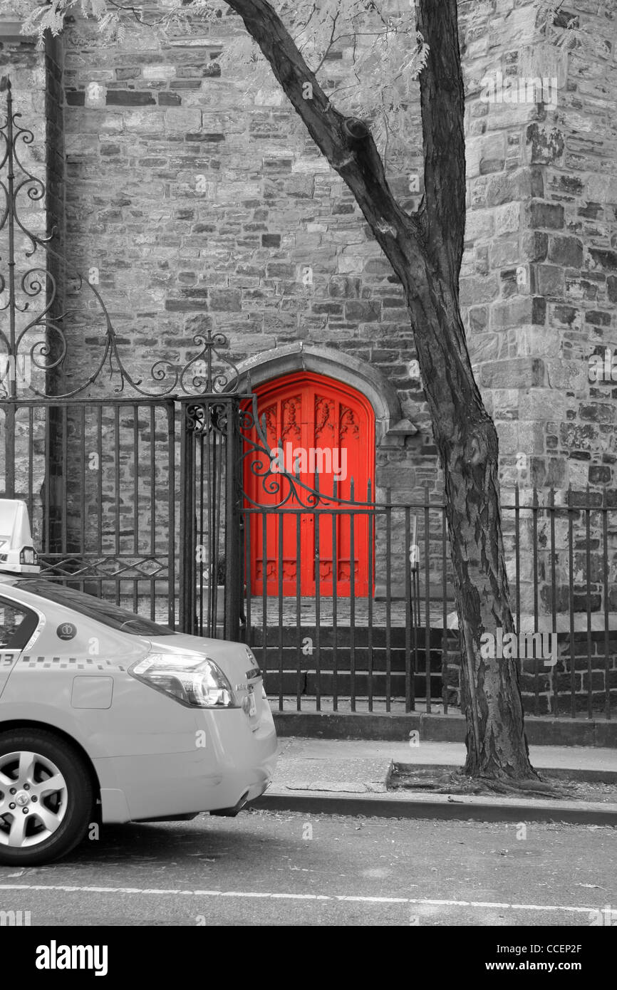 A cab is parking in front of a red door Stock Photo - Alamy