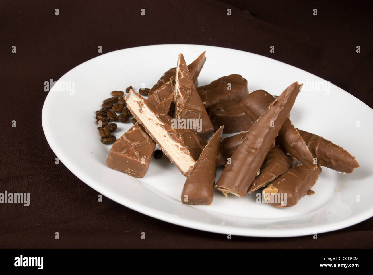 chocolate plate on the dark brown background Stock Photo - Alamy