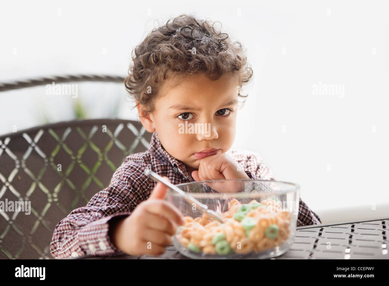 Grumpy child disappointed with his breakfast Stock Photo - Alamy