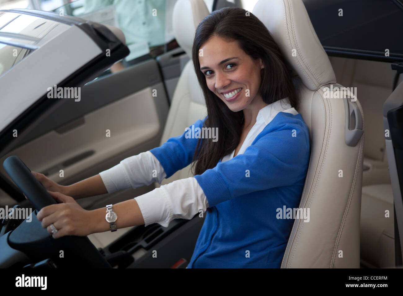 Portrait of smiling woman sitting in front seat of car Stock Photo - Alamy