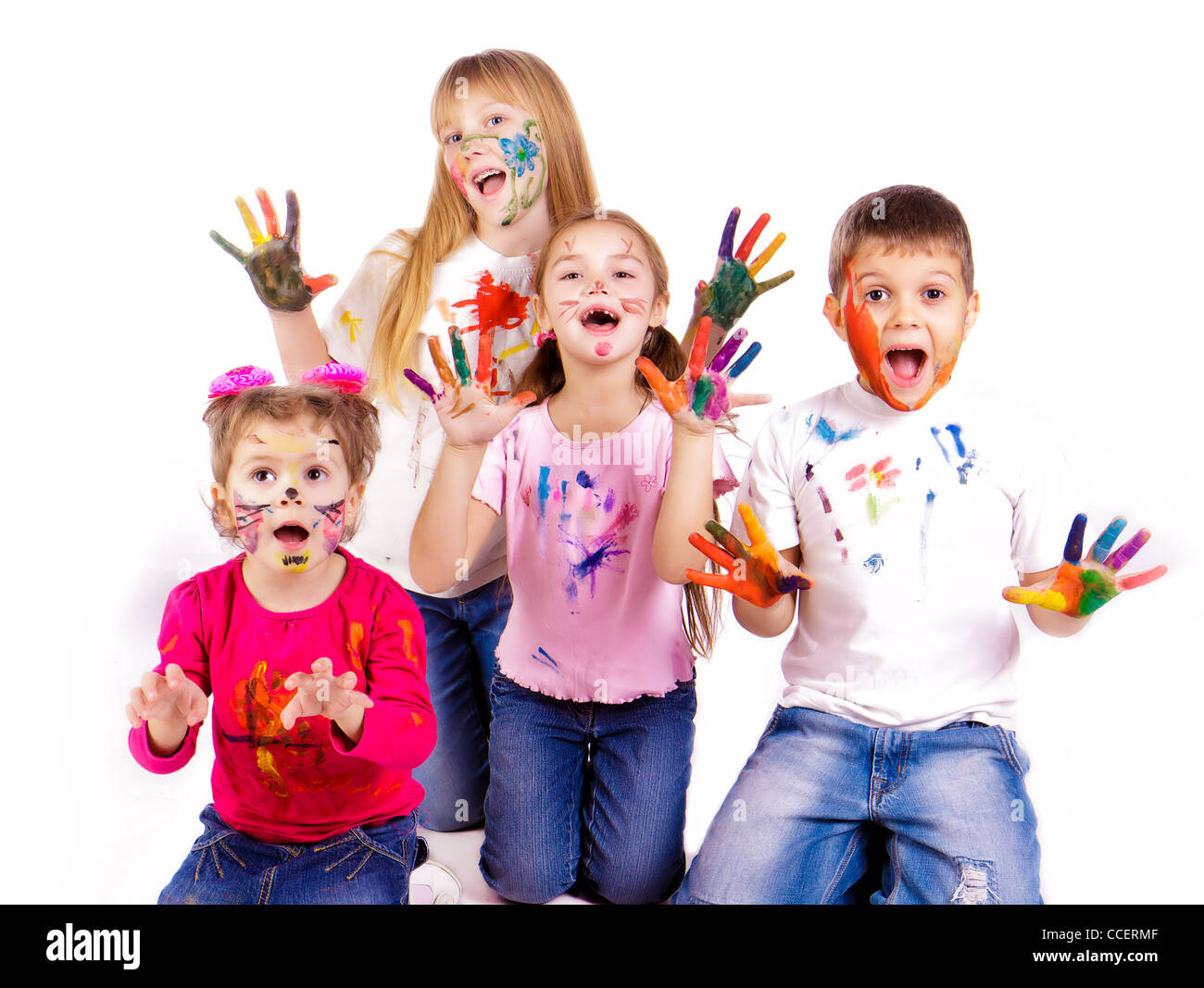 Happy kids with hands painted in colorful paints over white background ...