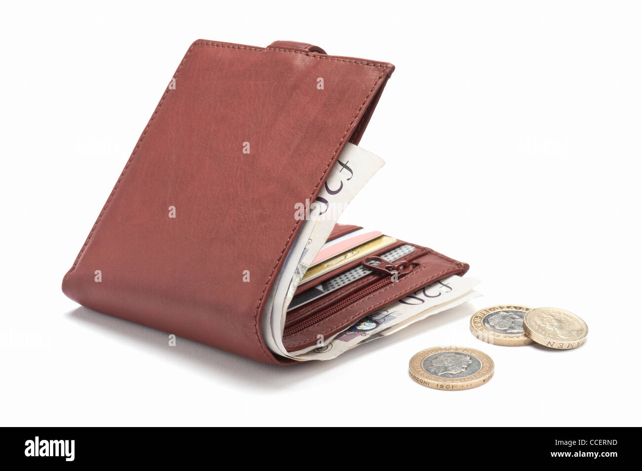 A brown leather wallet containing cards and British pounds Stock Photo ...