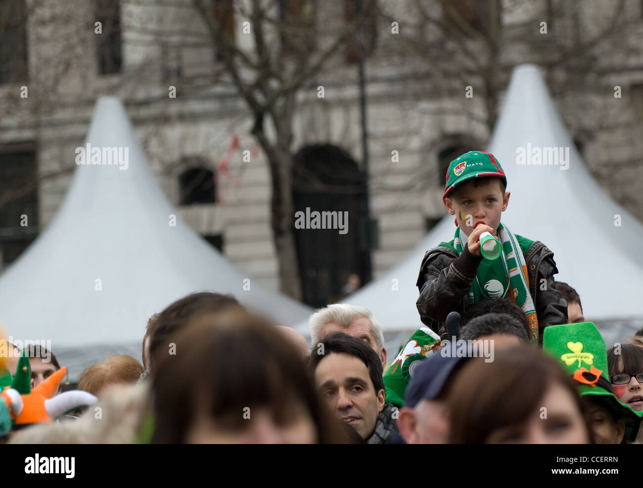 a young boy enjoys the st Patrick day festivities , whilst on top of ...