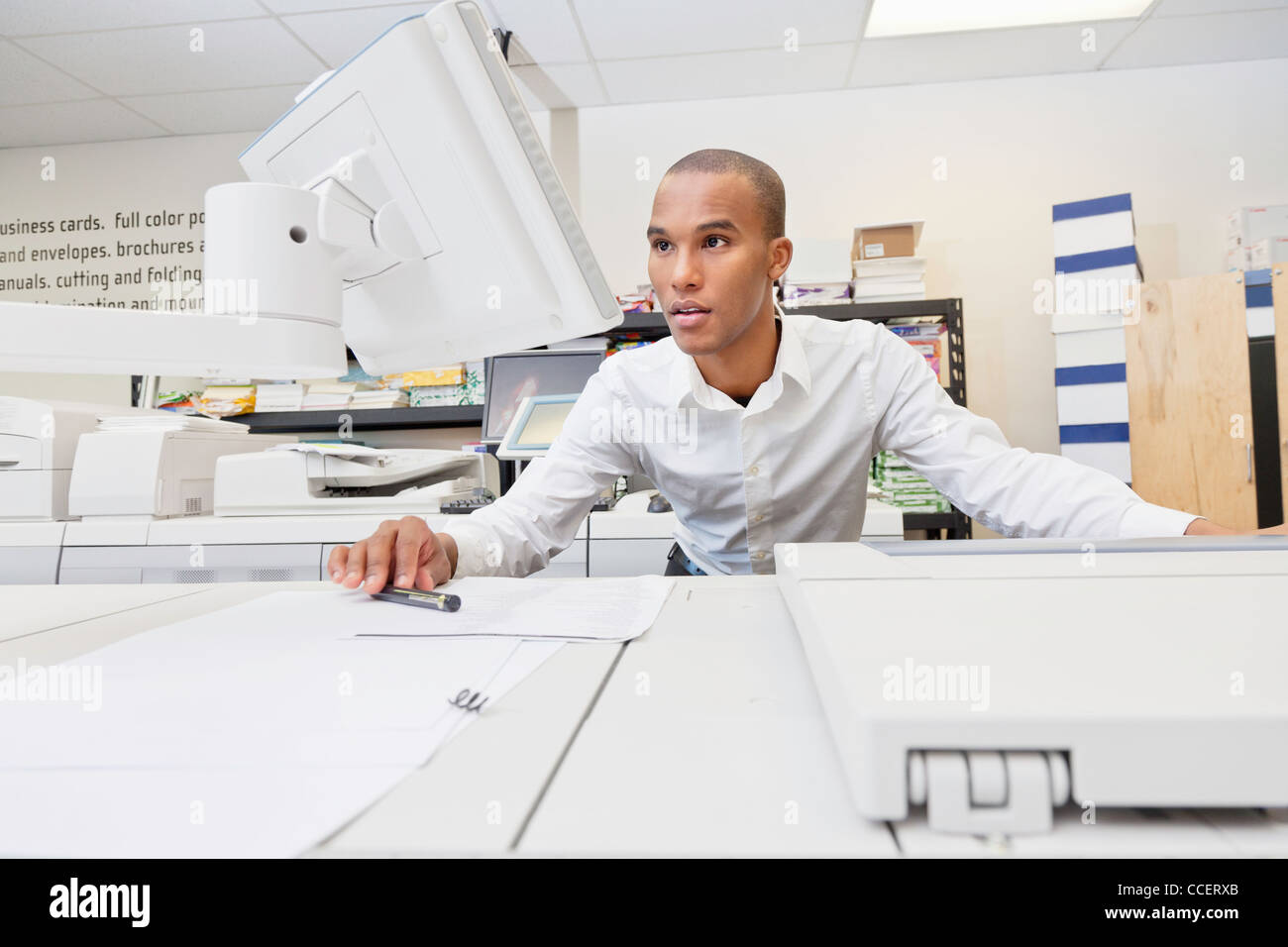 Man looking at visual screen Stock Photo - Alamy