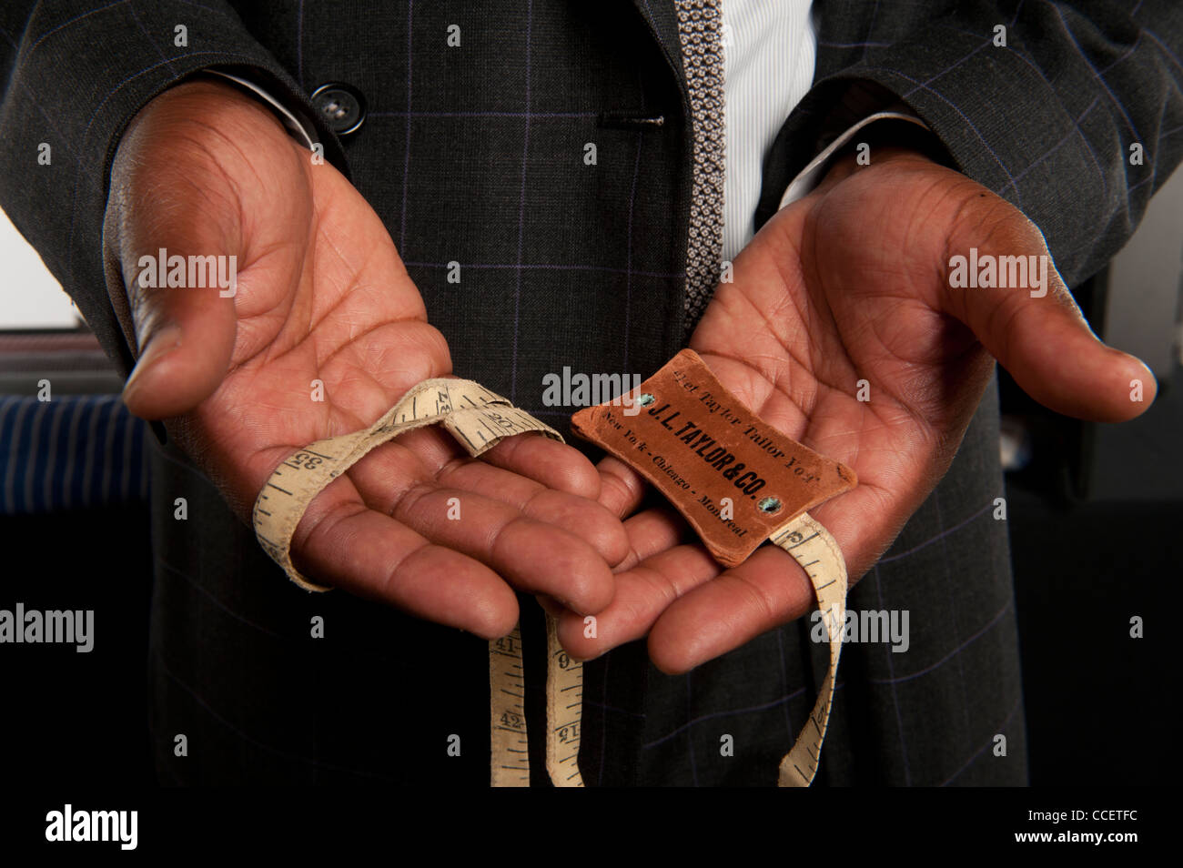 Close-up of hands holding measuring tape and tag Stock Photo - Alamy