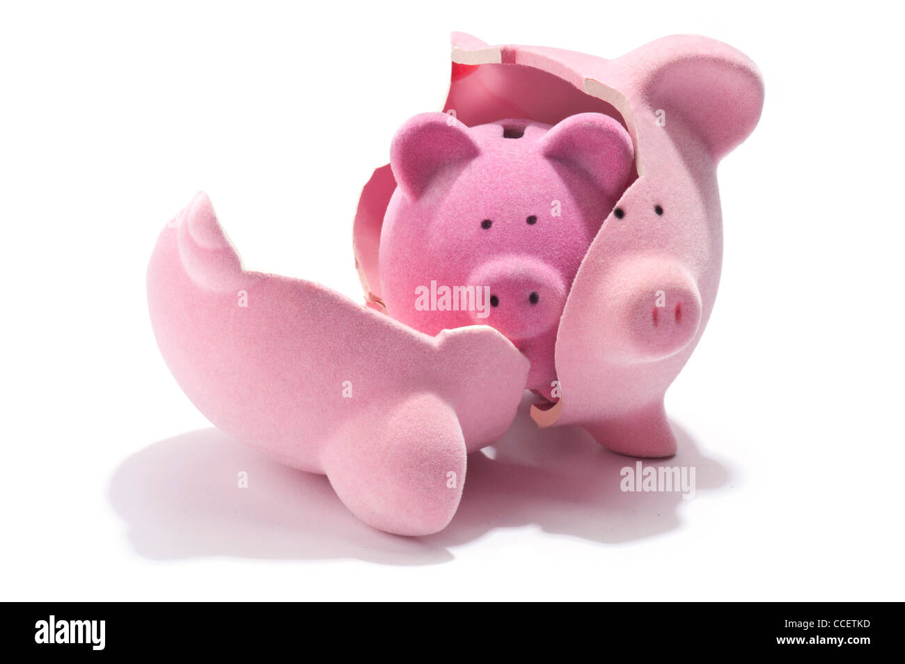 A small piggy bank inside a large broken piggy bank Stock Photo - Alamy