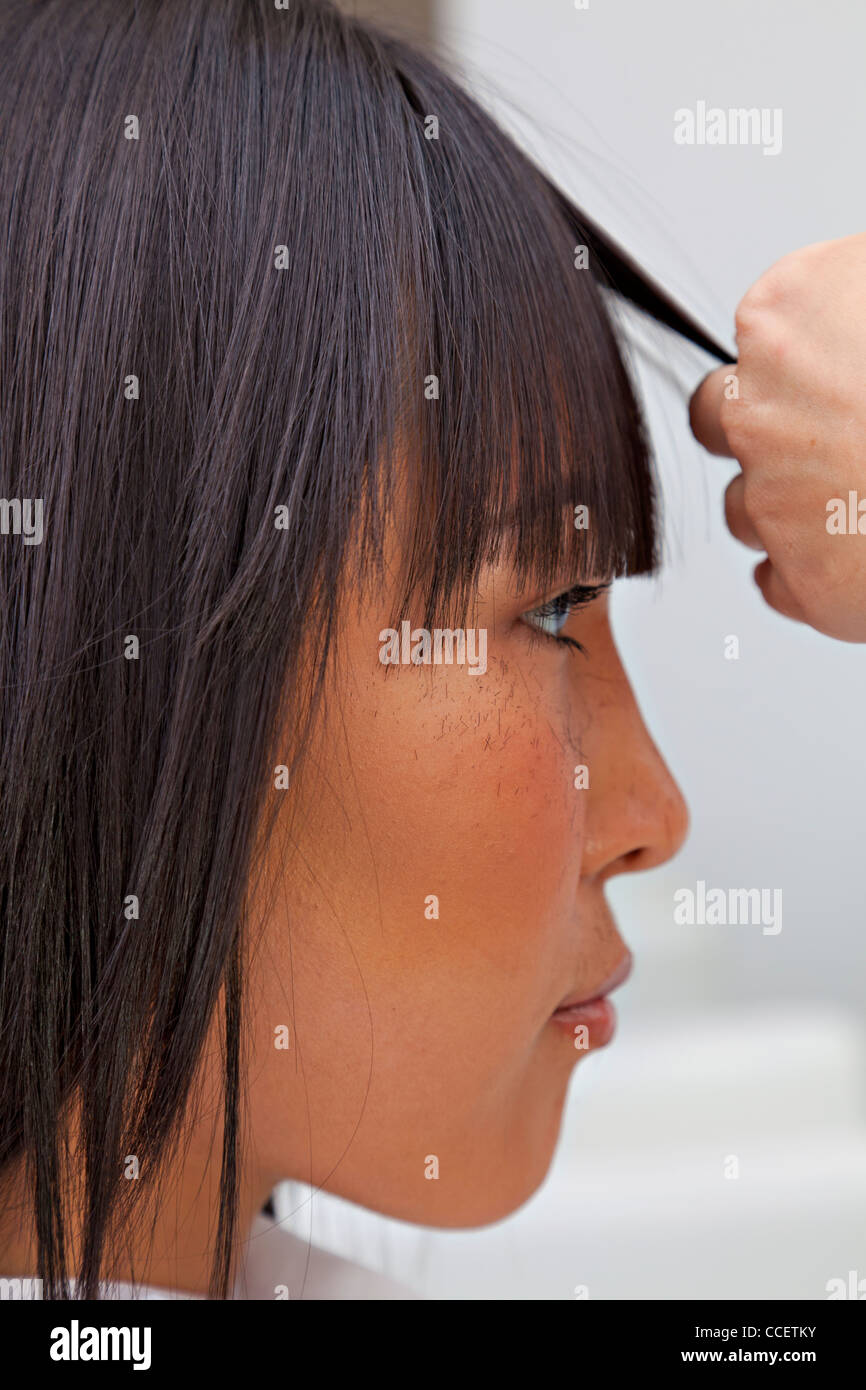 Side view of Asian woman getting a new haircut Stock Photo - Alamy