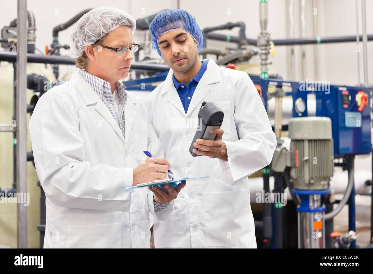 Two men working in bottling factory Stock Photo - Alamy