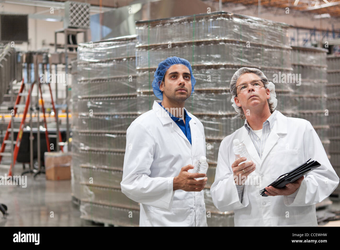 Quality control workers inspecting at bottling plant Stock Photo - Alamy