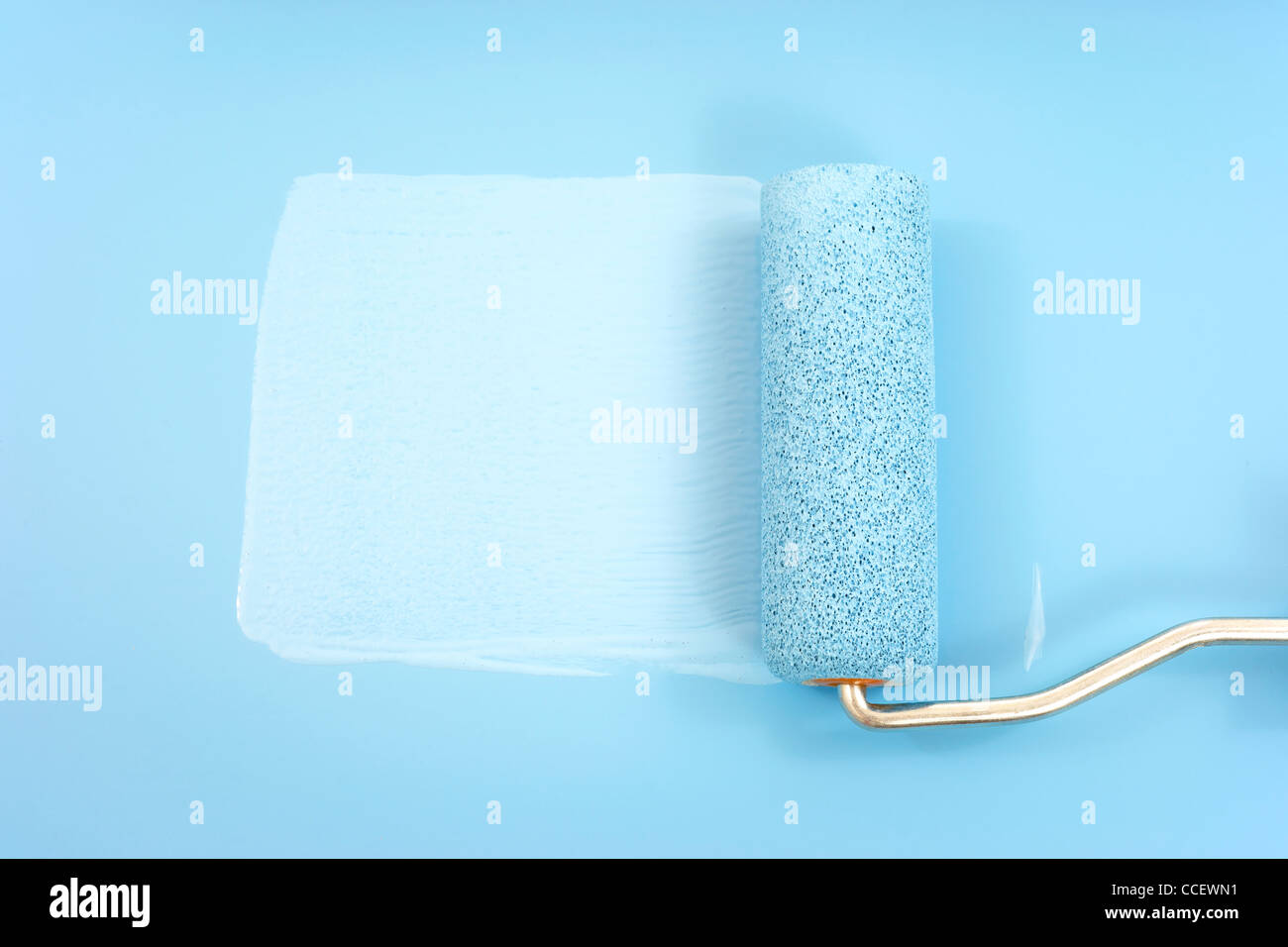 Paint roller and blue paint Stock Photo - Alamy