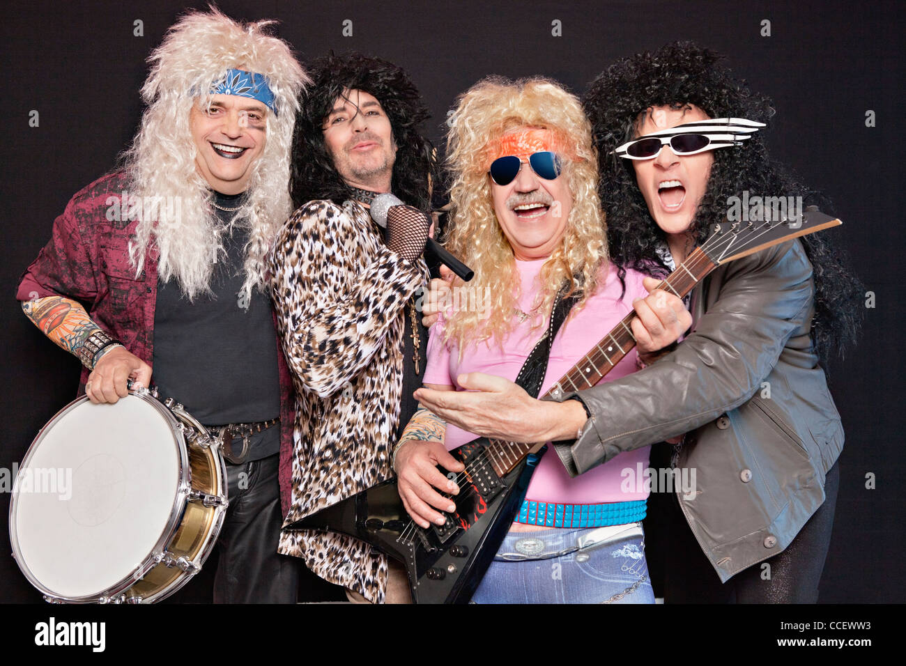 Group of cheerful musicians singing over black background Stock Photo ...