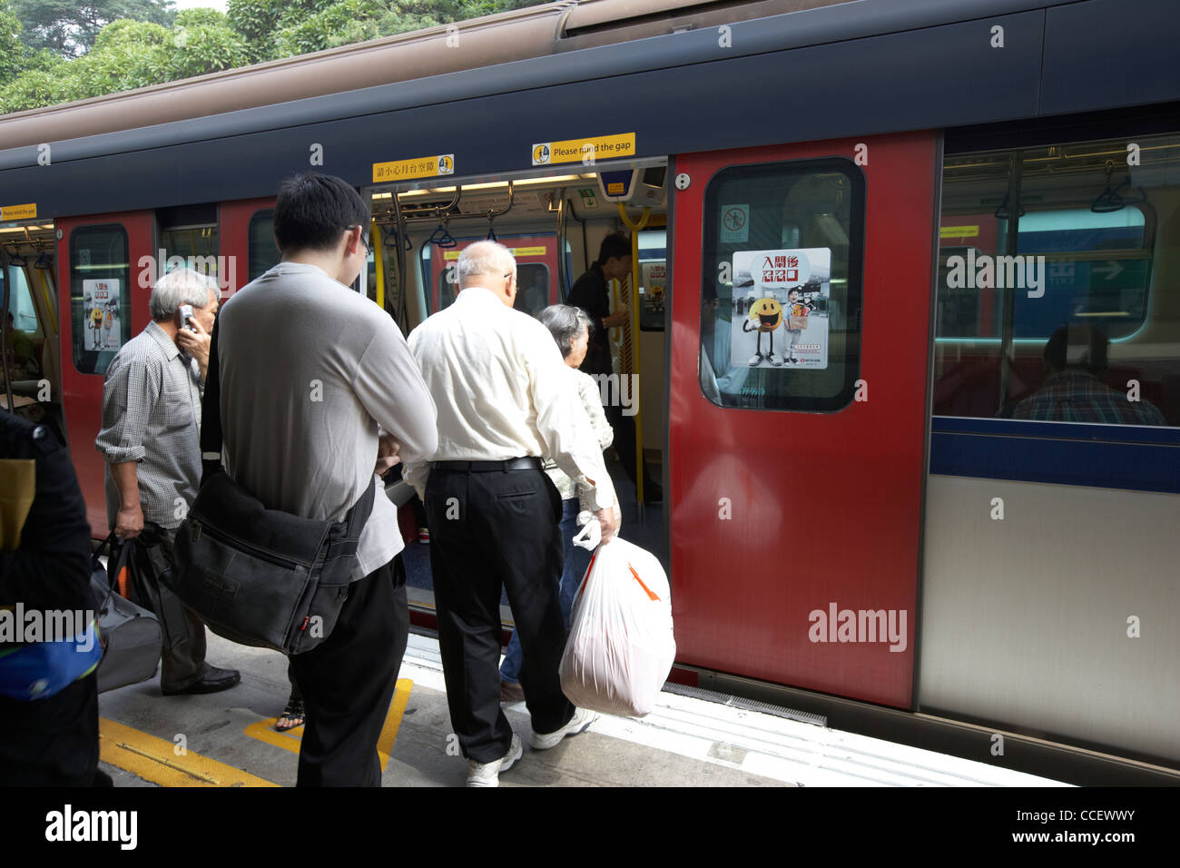 passengers boarding train on mtr overground line former kcr kowloon ...