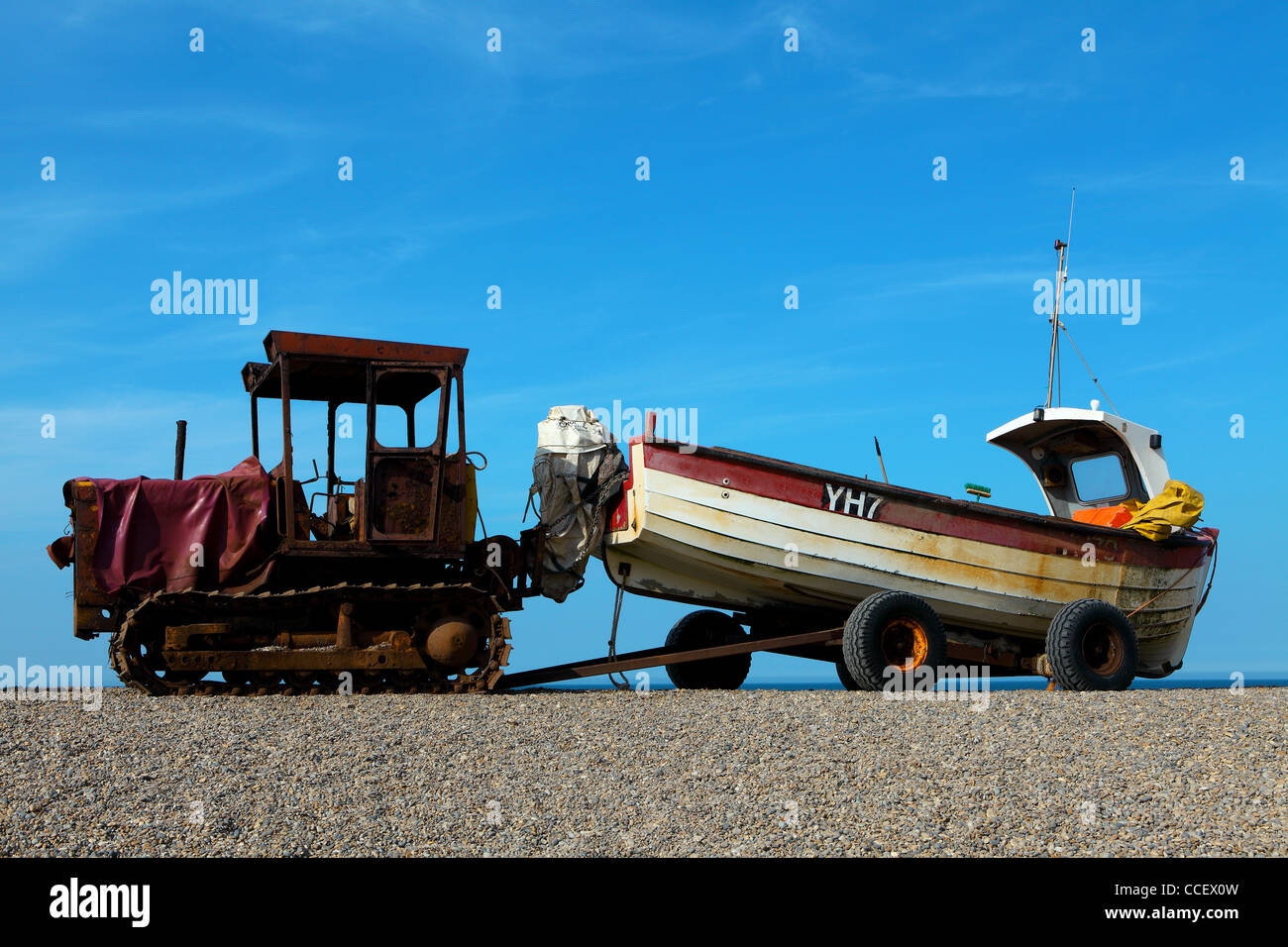 A boat and a tractor on a beach Stock Photo - Alamy