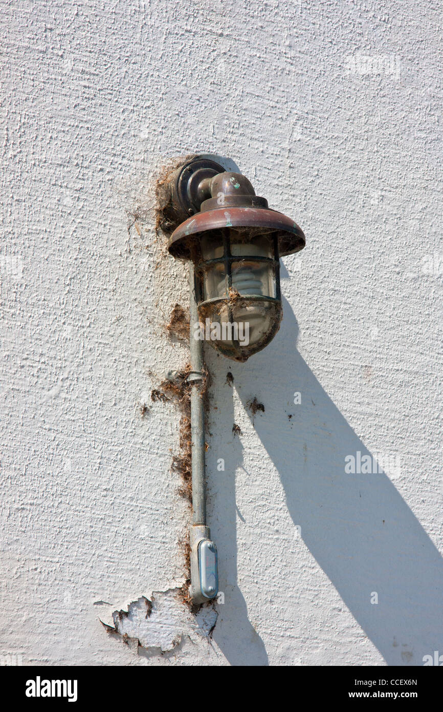 Old dirty wall lamp made of metal at house wall Stock Photo - Alamy