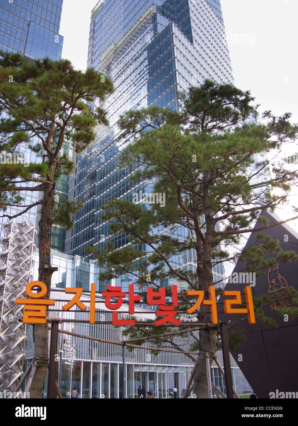 Modern Glass buildings and a huge street name sign in Seoul, Korea ...