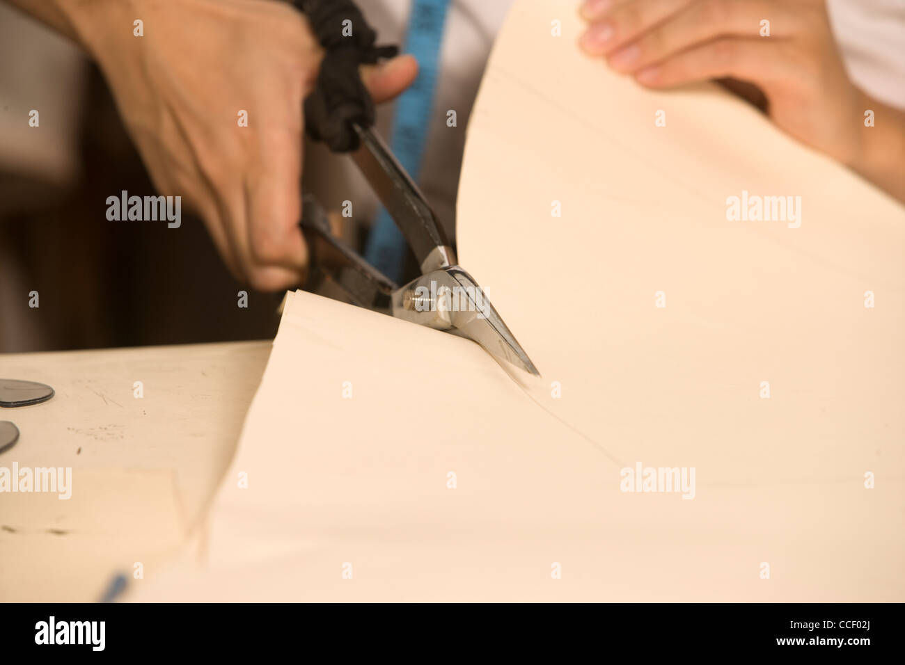 Cropped image of fashion designer cutting cloth Stock Photo - Alamy