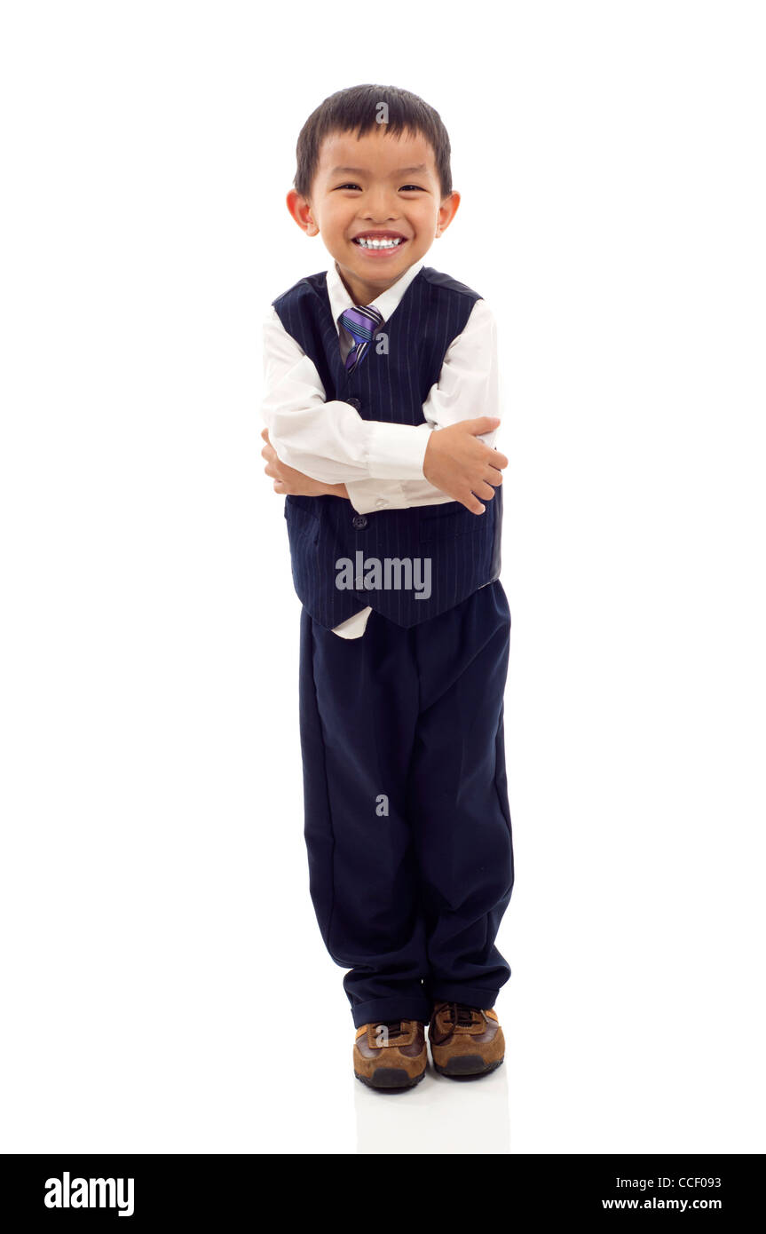 Full length portrait of a happy little Asian boy standing isolated over ...