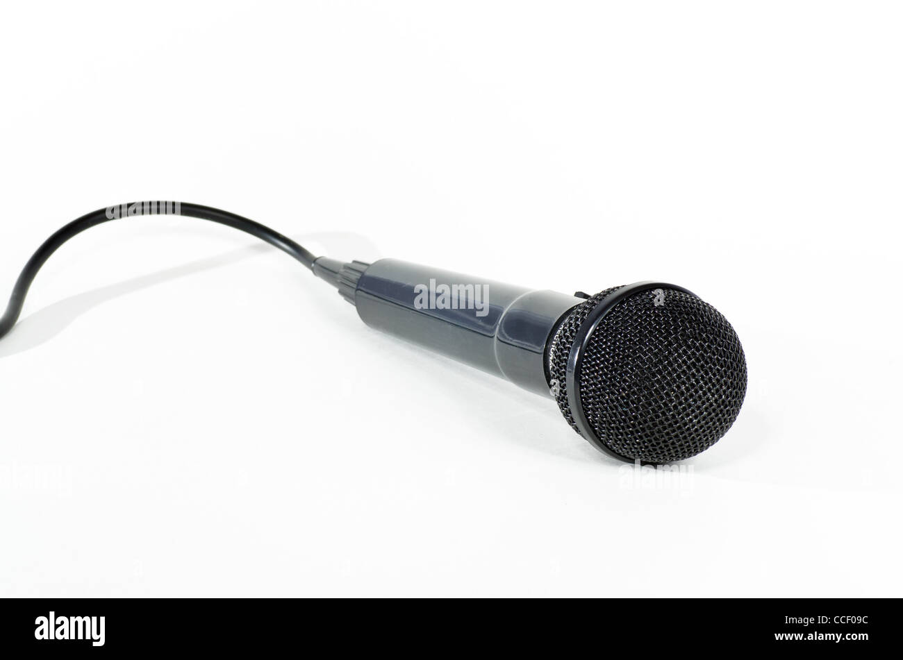 Black microphone with cord isolated against a white background Stock ...