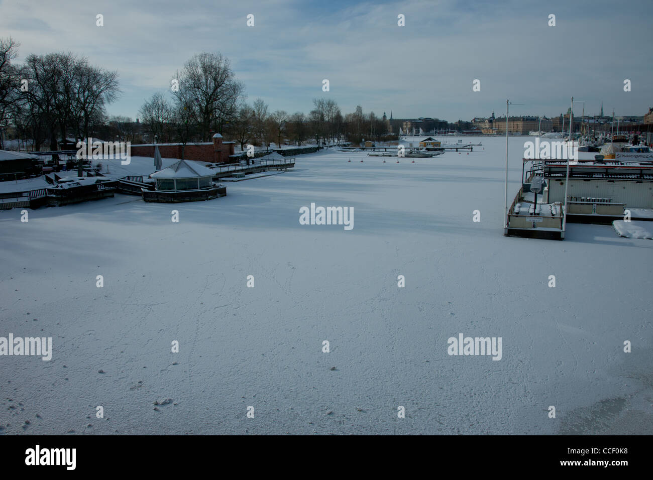 A frozen river is covered with snow in Stockholm, Sweden Stock Photo ...