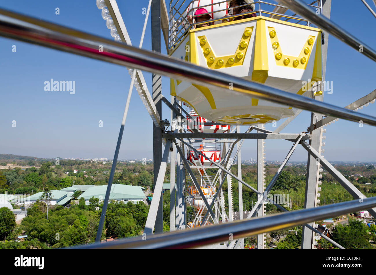 High up on Ferris wheel with passenger compartments at Royal Flora Expo ...