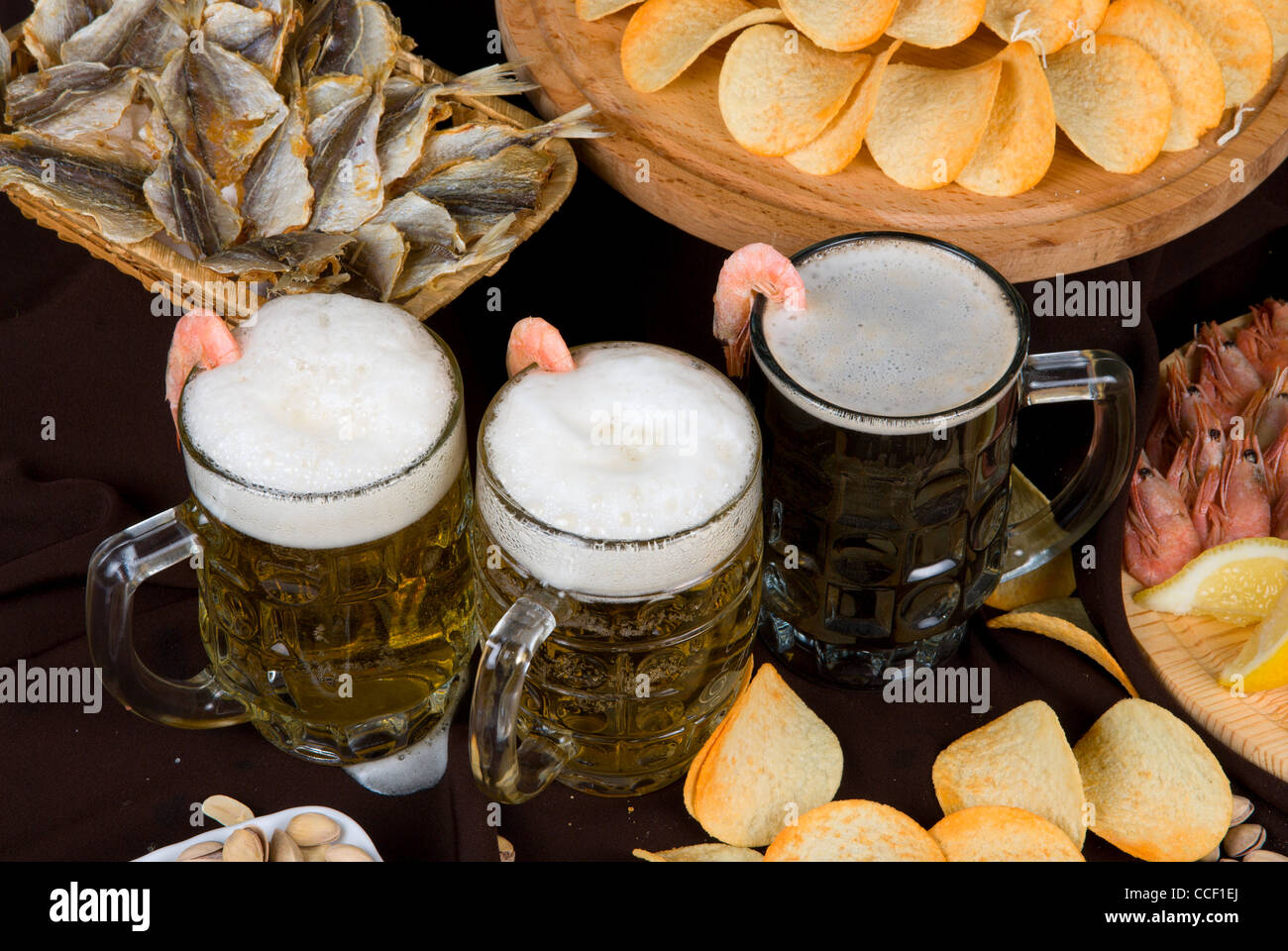 Beer and snacks set: chips, pistachio, shrimp and fish Stock Photo - Alamy