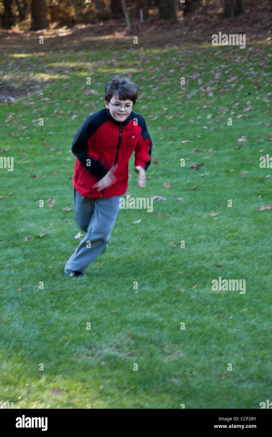 Young Boy Running on Lawn Stock Photo - Alamy