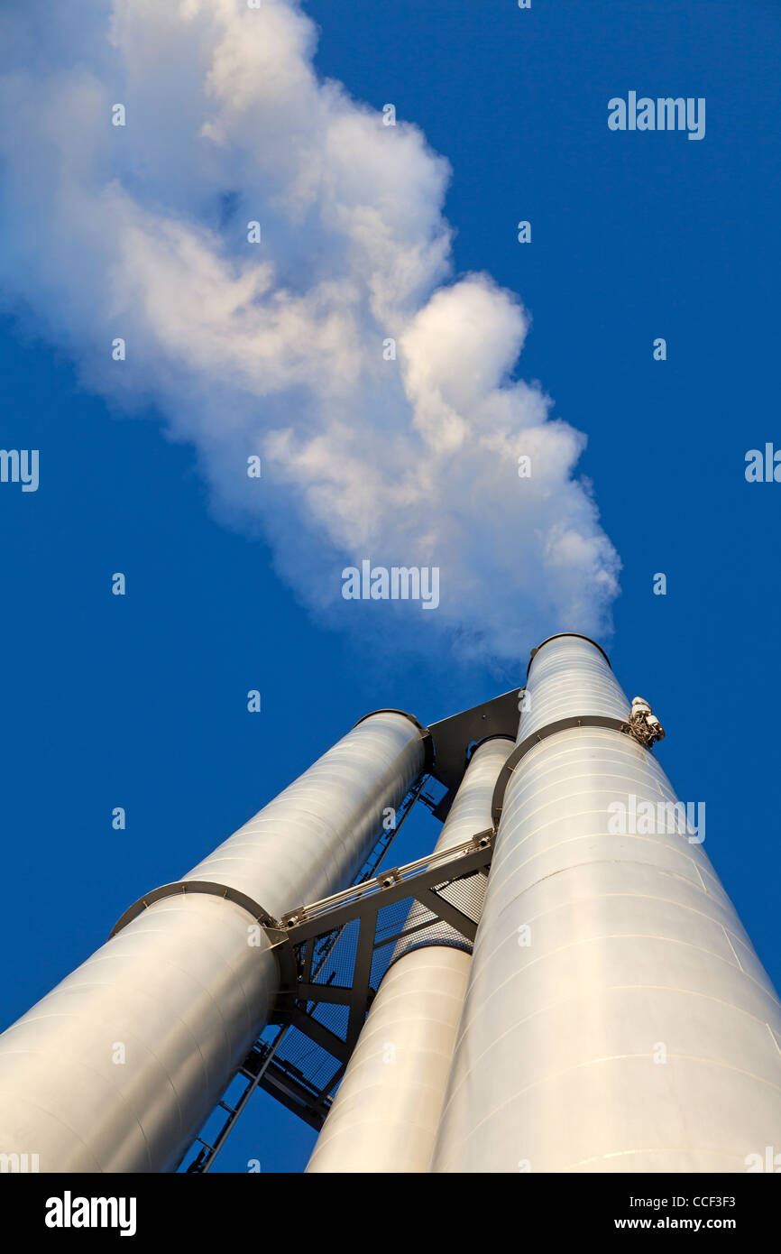 Smoking smokestack with blue sky Stock Photo - Alamy